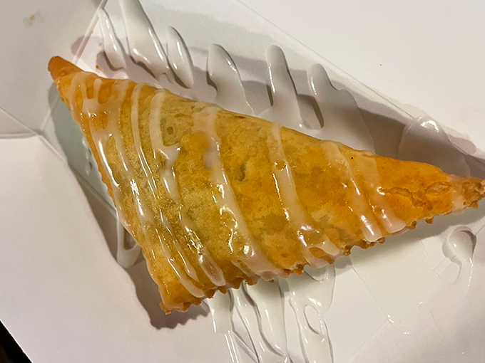 The fried pie glistens with sweet glaze, a portable pocket of Southern comfort that grandmothers everywhere would approve of.