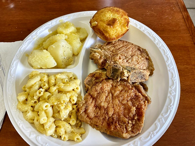 A plate that tells Georgia's culinary story – perfectly fried pork chop alongside mac and cheese that could make a grown person weep with joy.