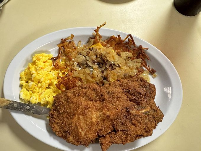 Golden-fried perfection meets fluffy scrambled eggs and hash browns. This plate doesn't just feed your body&mdash;it hugs your soul from the inside out.