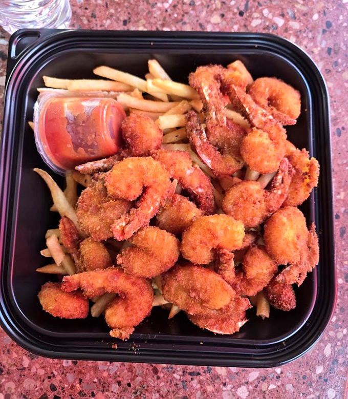 Golden-fried shrimp piled high atop french fries &ndash; proof that sometimes the simplest pleasures are the most satisfying, especially with that punchy cocktail sauce.