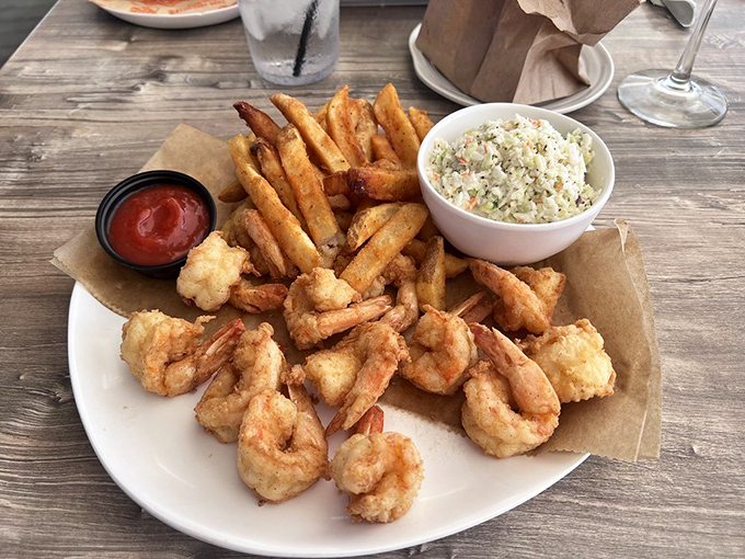 Golden-fried shrimp that snap between your teeth, crispy fries, and creamy coleslaw &ndash; the holy trinity of Florida seafood satisfaction.
