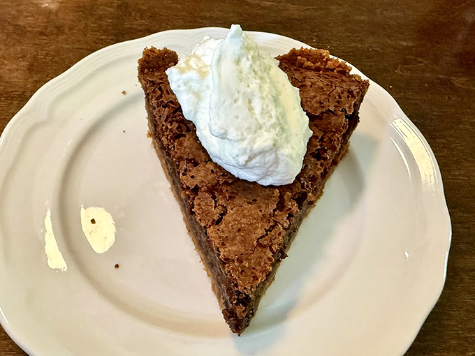 This slice of fudge pie topped with cloud-like whipped cream isn't just dessert&mdash;it's the reason buttons were designed to pop.