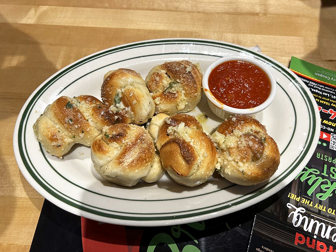 Garlic knots that could make a vampire reconsider their life choices. That marinara dipping sauce? Pure liquid gold.