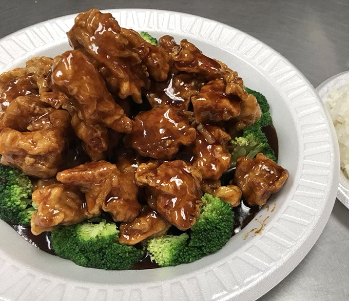 General Tso's Chicken done right &ndash; crispy, glossy, and nestled on a bed of vibrant broccoli like edible jewels on a verdant cushion.