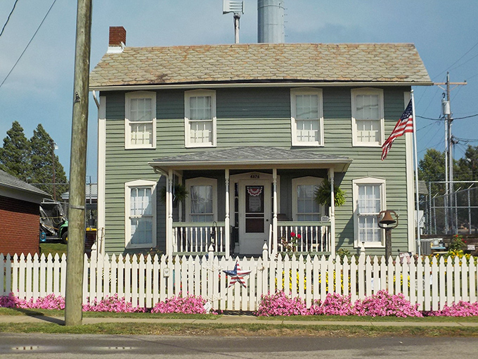 The charming green house with white picket perfection. Norman Rockwell couldn't have painted a more quintessential slice of small-town America.