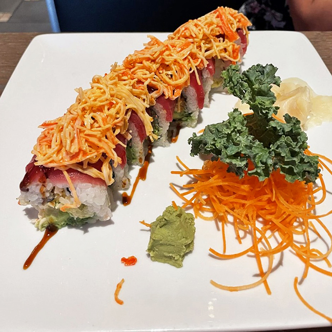 This isn't just a roll; it's architecture. Crispy tempura shrimp crowned with vibrant tuna and that signature crunch.