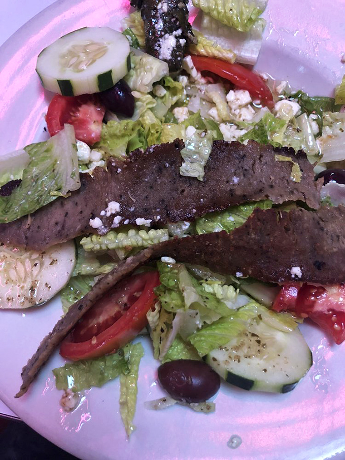 Even the Greek salad gets the royal treatment, with generous slabs of gyro meat lounging atop crisp vegetables like they own the place.