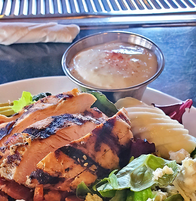Grilled chicken that actually tastes like chicken &ndash; what a concept! &ndash; served alongside fresh greens and house-made dressing.