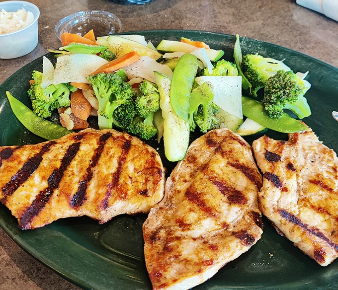 Perfectly grilled chicken breast meets vibrant vegetables—proof that "diner food" and "healthy option" aren't mutually exclusive concepts after all.