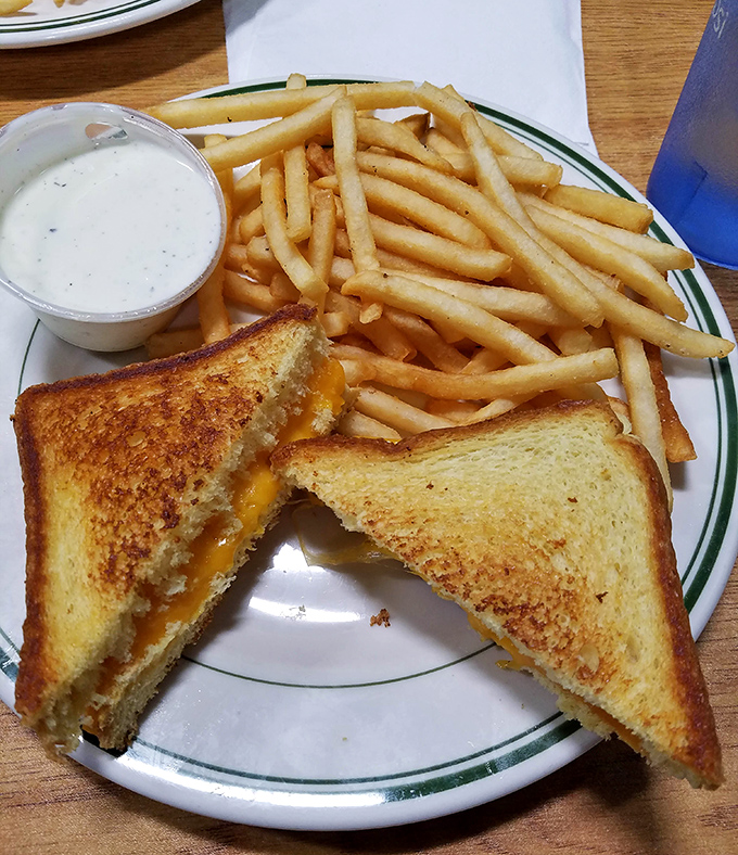 The grilled cheese arrives golden-brown and perfectly melted, proving simple done right beats complicated done wrong every time.