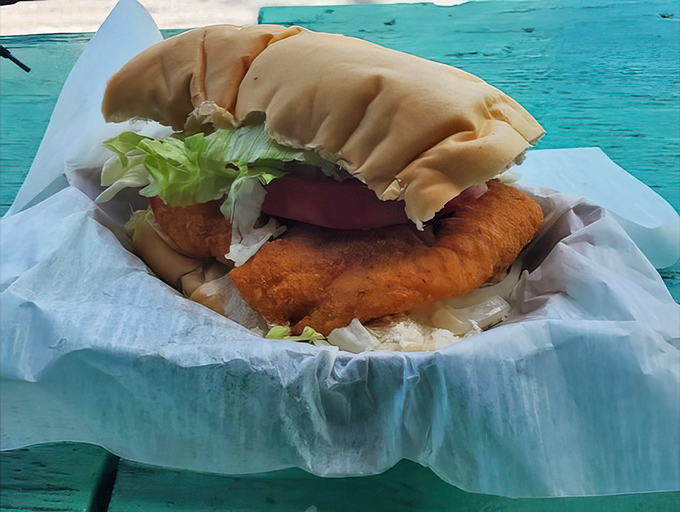 This grouper sandwich refuses to be contained by mere bread &ndash; it's making a break for freedom and flavor.