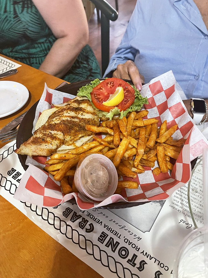 This grouper sandwich isn't just lunch; it's Florida sunshine on a bun with those golden fries standing at attention.