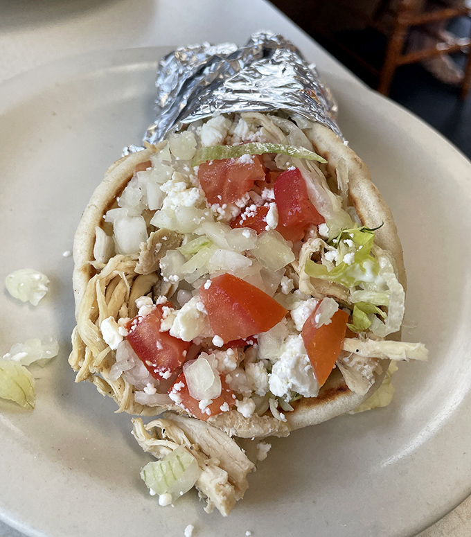 This gyro isn't just a sandwich; it's a Mediterranean vacation wrapped in foil, with feta playing the role of beach sand.