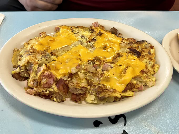 The breakfast scramble that launched a thousand road trips. Melted cheese blankets potatoes, eggs, and meat in a harmony of comfort.
