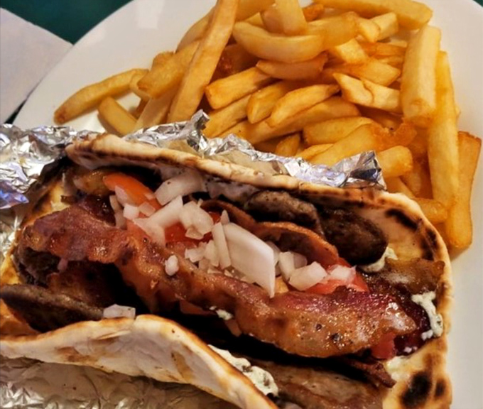 The legendary gyro &ndash; where seasoned meat, fresh veggies, and tzatziki come together in a handheld miracle that makes you forget fancy dining exists.