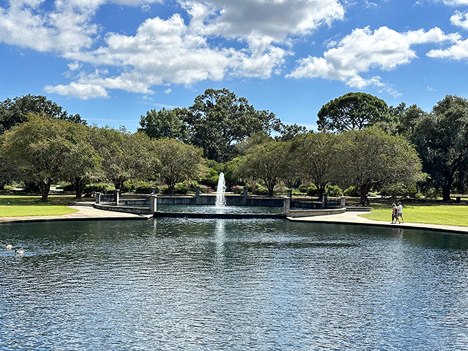 Hampton Park's serene waters reflect Charleston's blue skies, offering a peaceful respite where locals have been escaping the bustle since long before "mindfulness" became trendy.