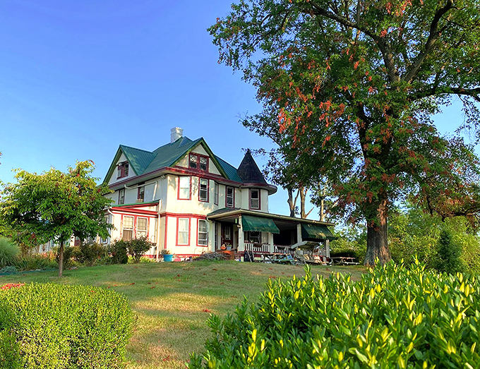 This charming Victorian home sits like a colorful illustration from a storybook, proving that picturesque living doesn't require a fairy tale budget.