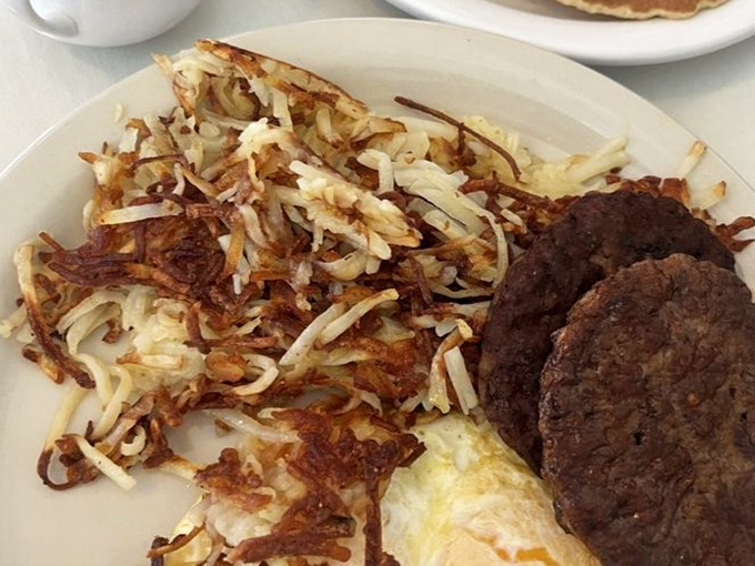 These hash browns achieve the impossible trifecta: crispy edges, tender centers, and enough butter to make your cardiologist wince.