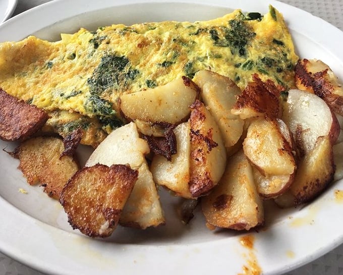 This isn't just an omelet with home fries&mdash;it's a masterclass in breakfast architecture where crispy edges meet fluffy interiors in perfect harmony.
