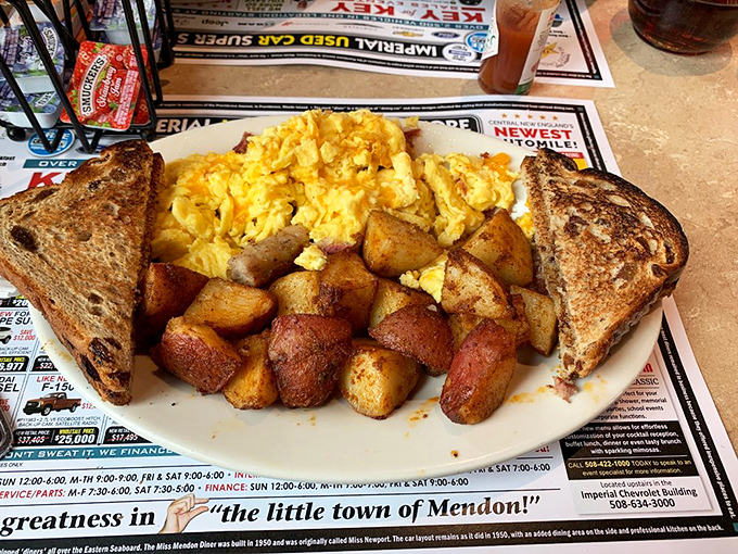 The breakfast trinity: perfectly scrambled eggs, golden-brown home fries, and toast that's actually toasted properly. Simple pleasures on a plate.