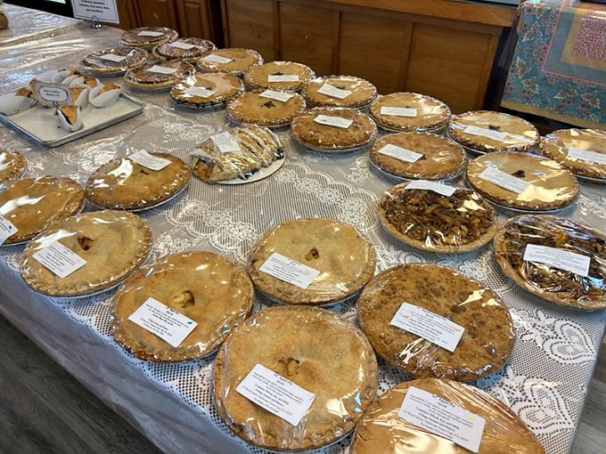 The pie lineup looks like a family reunion where everyone actually gets along. Each golden crust holds secrets that grandmothers would fight to claim as their own.