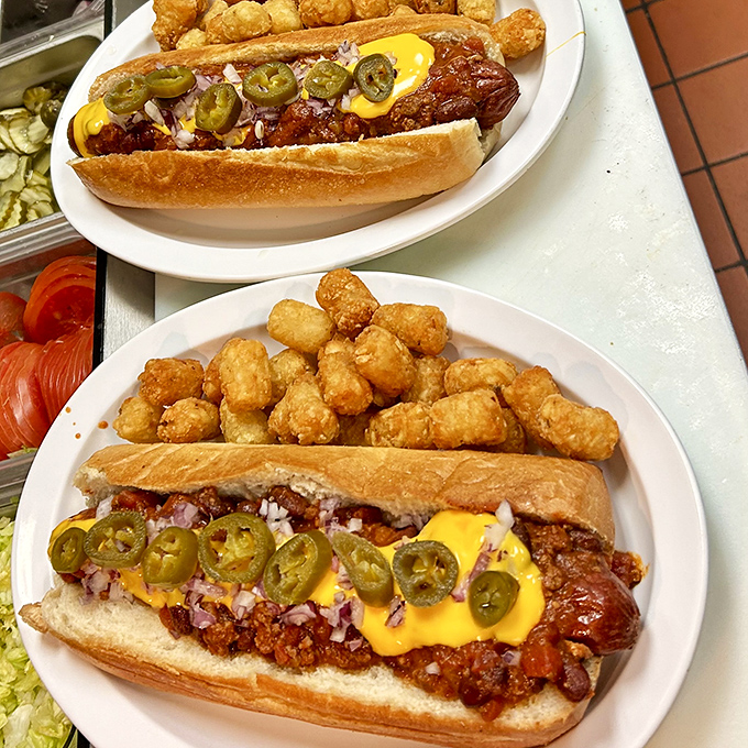 These aren't just hot dogs—they're architectural masterpieces where jalapeños, chili, and cheese create a symphony in a bun.