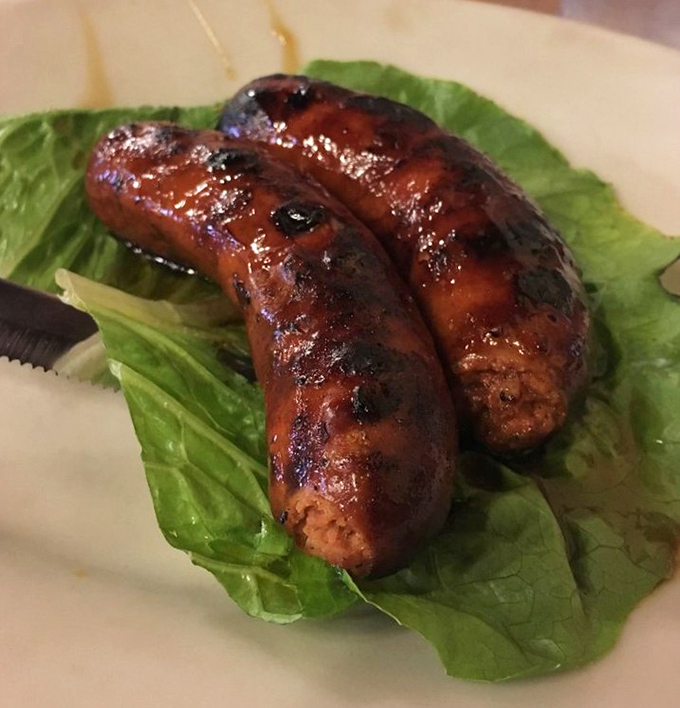 These hot links aren't just sausages; they're flavor grenades waiting to detonate on your taste buds. Crisp lettuce underneath? Nature's noble attempt at balance.