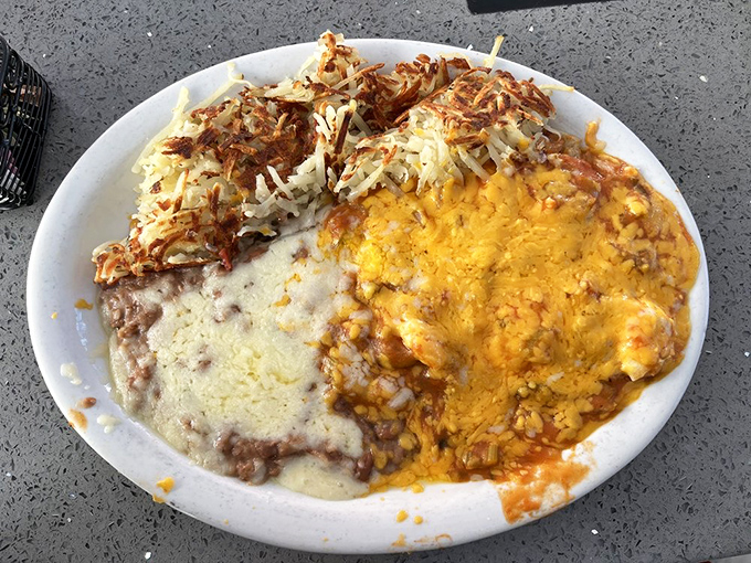 This mountain of cheesy, saucy goodness is what breakfast dreams are made of&mdash;hash browns on one side, melted cheddar blanketing the other.