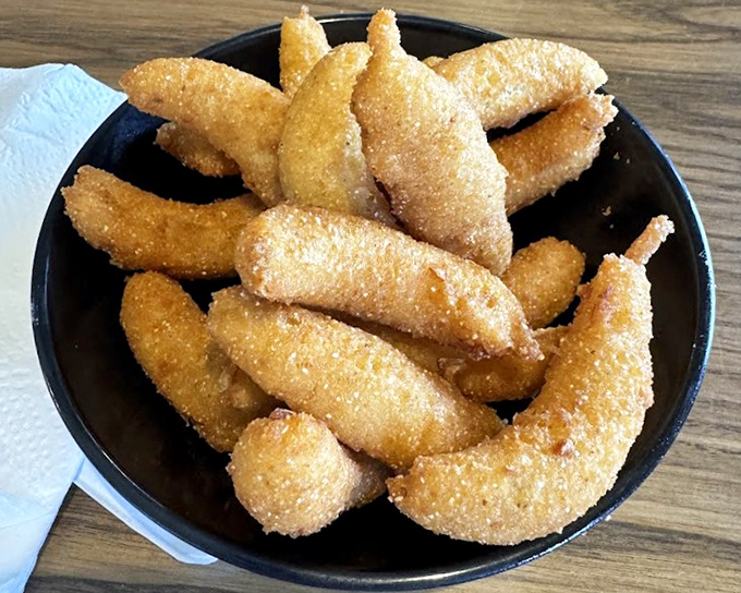 These aren't just hush puppies—they're golden orbs of cornmeal joy that would make even a seafood skeptic weak at the knees.