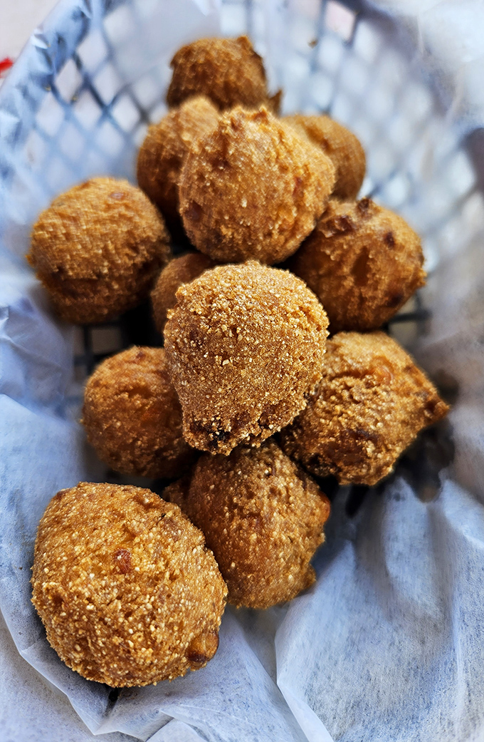 Golden-brown hush puppies huddle together in their basket, waiting to be dipped in honey butter&mdash;the perfect sweet counterpoint to all that savory seafood.
