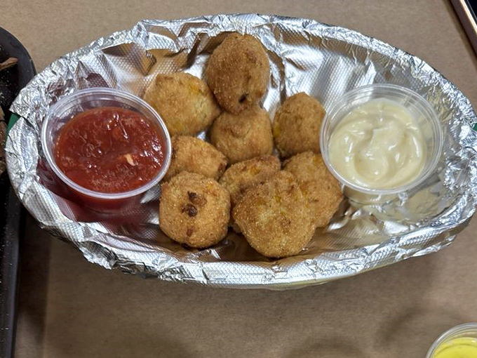 Golden-fried hush puppies with dipping sauces&mdash;the perfect supporting actors in your crab feast drama. Crispy outside, tender inside, completely irresistible.