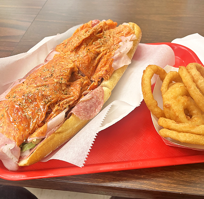 The Italian sub arrives like a colorful edible mosaic&mdash;layers of meat, cheese, and veggies under a drizzle that ties everything together.