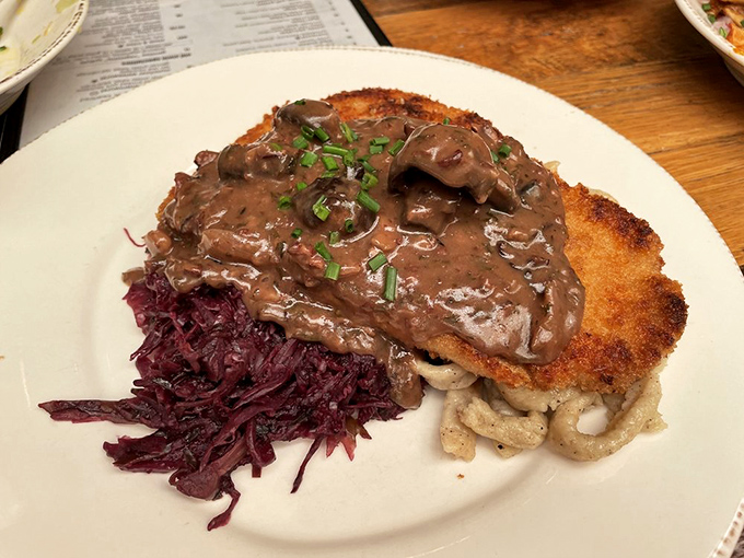 Jagerschnitzel: where a golden-fried cutlet meets a mushroom gravy so good you'll want to bathe in it. The red cabbage adds that perfect sweet-tart balance.