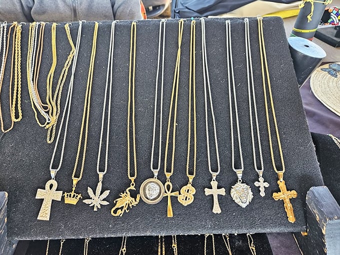 Gold chains and symbolic pendants glimmer under the market lights—one person's discarded jewelry becomes another's newfound treasure.