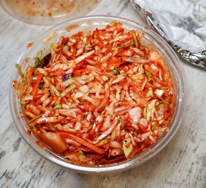 This isn't your grandmother's coleslaw (unless your grandmother was secretly Korean). The kimchi slaw delivers a perfect punch of tangy, spicy crunch to cut through rich barbecue.