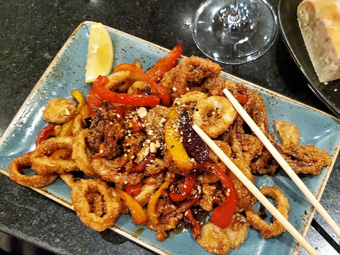 Kung Pao Calamari brings the crunch, the spice, and enough colorful peppers to make you forget you're eating something with tentacles.
