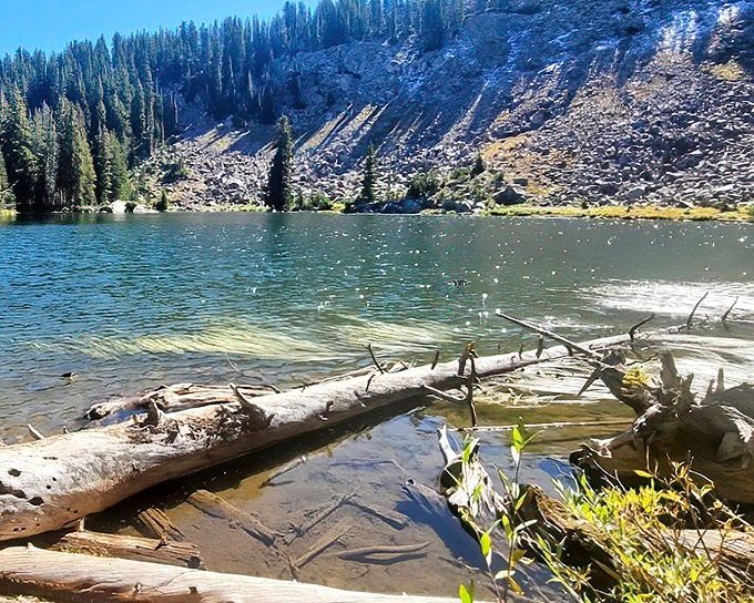 This alpine lake doesn't just reflect the mountains &ndash; it captures their soul, holding the essence of wilderness in its crystal-clear depths.