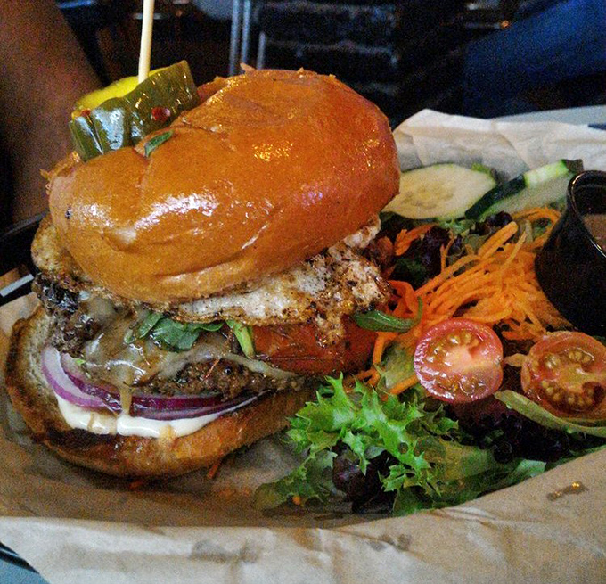 The Lamb Burger arrives like a Mediterranean vacation between two buns. Those vibrant veggies aren't just garnish&mdash;they're supporting actors.