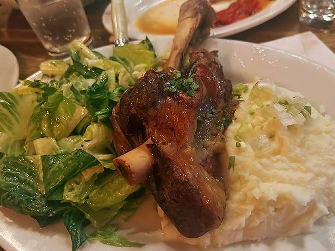 This isn't just any lamb shank &ndash; it's a masterclass in slow-cooking, where meat surrenders completely from the bone alongside creamy mashed potatoes.