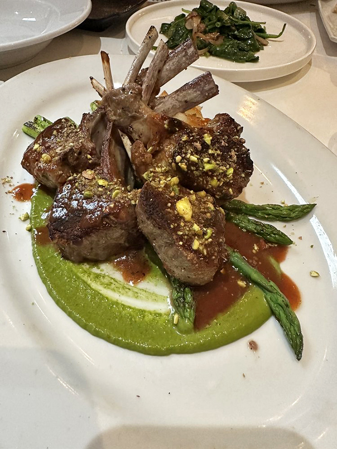 Rack of lamb that stands at attention like it's auditioning for a Michelin star. That mint pesto base isn't just green&mdash;it's money.