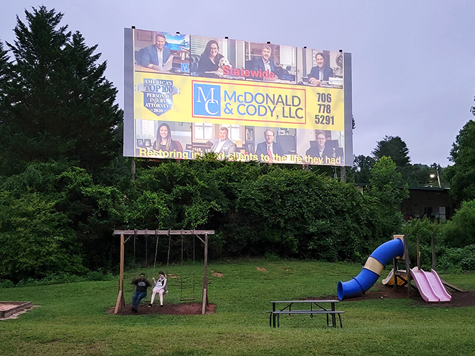 The towering screen stands ready to transport you to other worlds beneath the open sky.