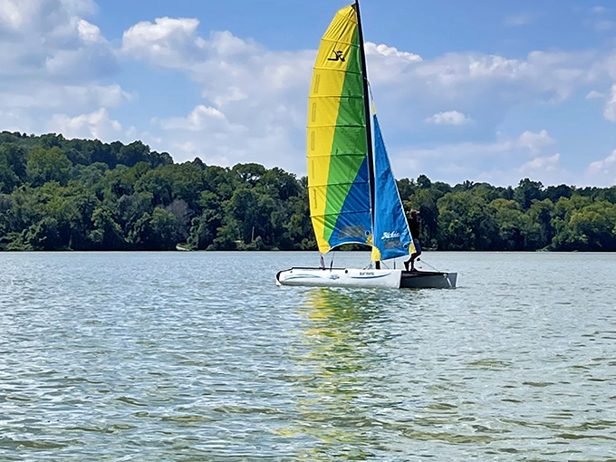 A colorful sailboat cuts through blue waters like a paintbrush on canvas. Some people find their zen in yoga; others find it here.