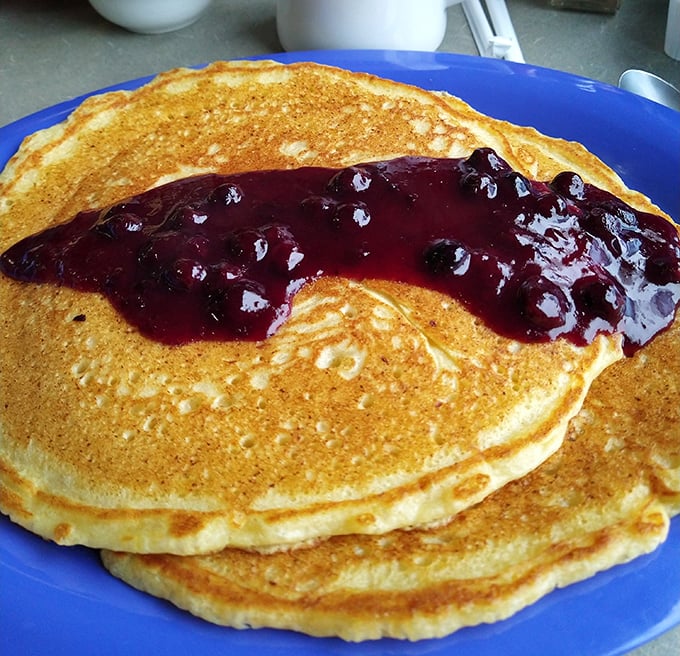 Golden-edged pancakes topped with berry compote—each bite a perfect balance of tangy and sweet, like breakfast's greatest hits album.