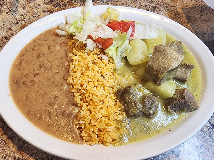 Lengua (beef tongue) in green sauce &ndash; a dish that converts the skeptical into believers with its melt-in-your-mouth texture and bright, herbaceous bath.