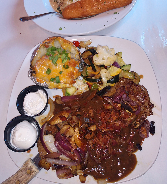 A loaded baked potato steals the spotlight from this hearty steak smothered in mushroom gravy &ndash; supporting actors deserve Oscars too!