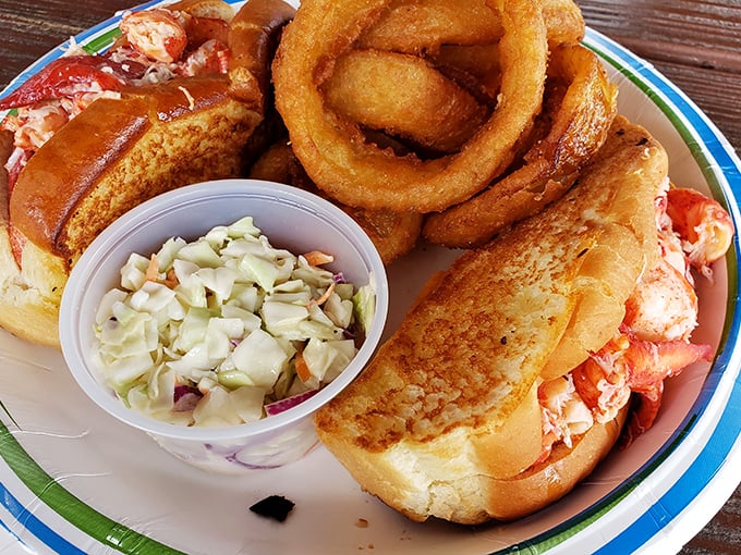 Lobster roll perfection: sweet meat, buttery bun, and those onion rings that make you forget your cardiologist's name.