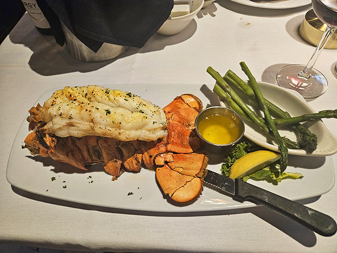 This isn't just lobster tail—it's maritime royalty holding court with asparagus sentries and drawn butter that's practically liquid sunshine.