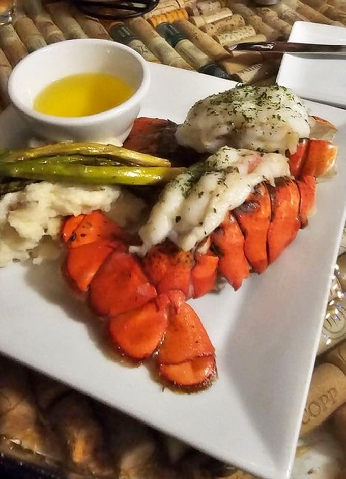 This lobster tail isn't just dinner &ndash; it's maritime royalty dressed in butter and herbs, flanked by asparagus soldiers standing at attention.