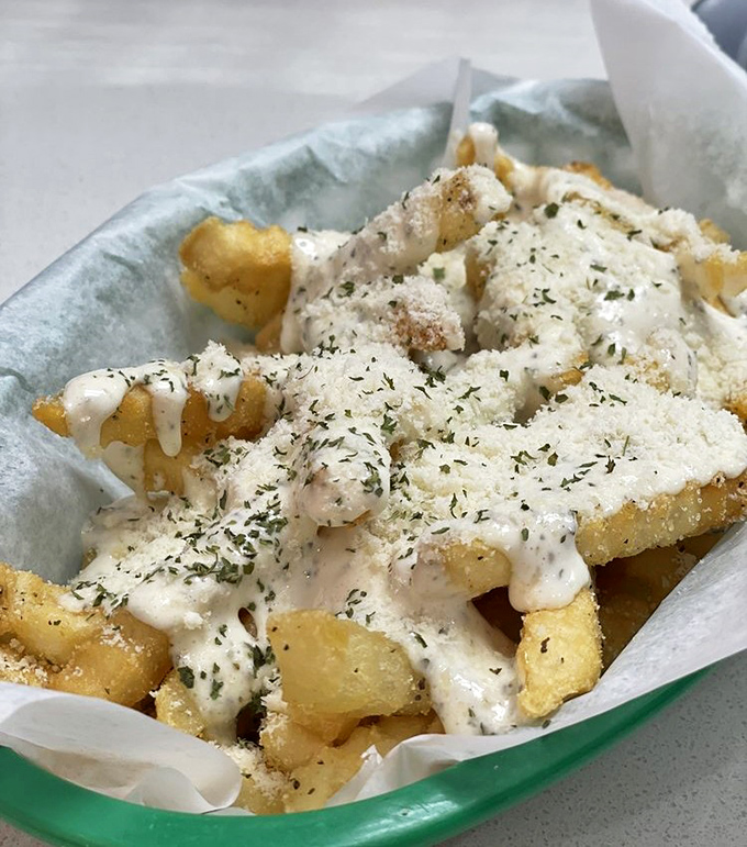 Lucino's Fries aren't sidekicks but stars, draped in creamy sauce and herbs that transform the humble potato into something worth fighting over.