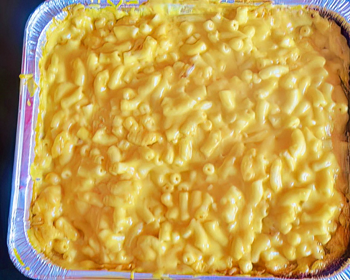 Mac and cheese so gloriously yellow it could guide ships to shore. This isn't just comfort food&mdash;it's a warm hug on a plate.